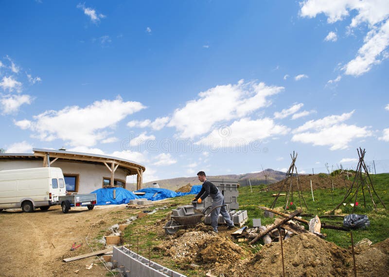 Man building a house stock photo. Image of brick, concrete - 53956396
