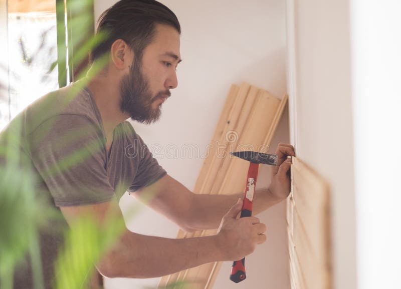 Man Building a House and Workimg with Hammer and Wood Stock Image ...
