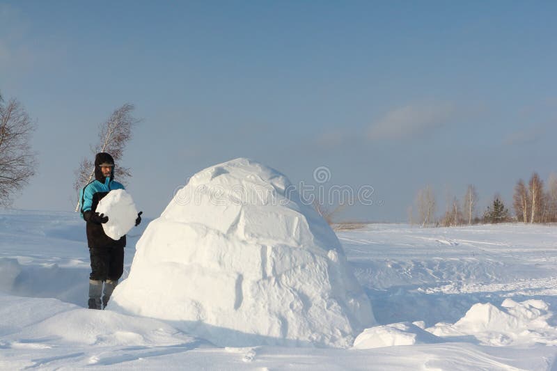 Man Building an Igloo in a Blizzard Stock Image - Image of coast, copy ...