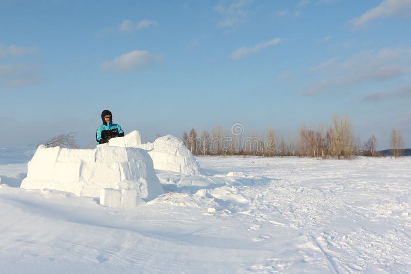 Man Building an Igloo of Snow Blocks Stock Photo - Image of cold, lump ...