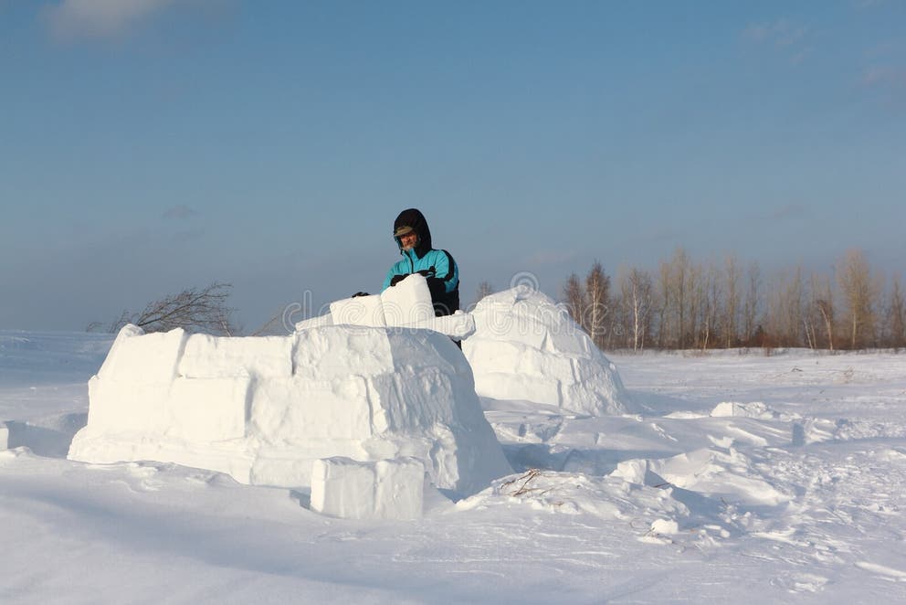 Man Building an Igloo of Snow Blocks in the Winter Stock Photo - Image ...