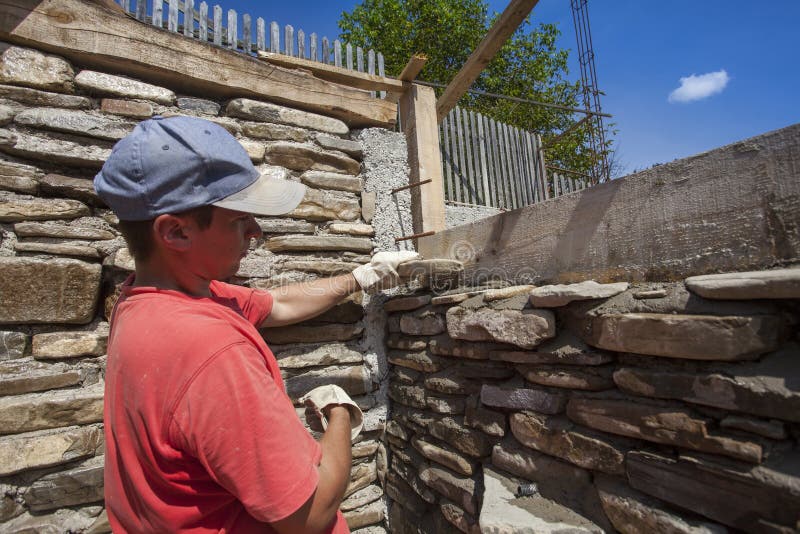 Man building stone wall stock photo. Image of hard, occupation - 156865054