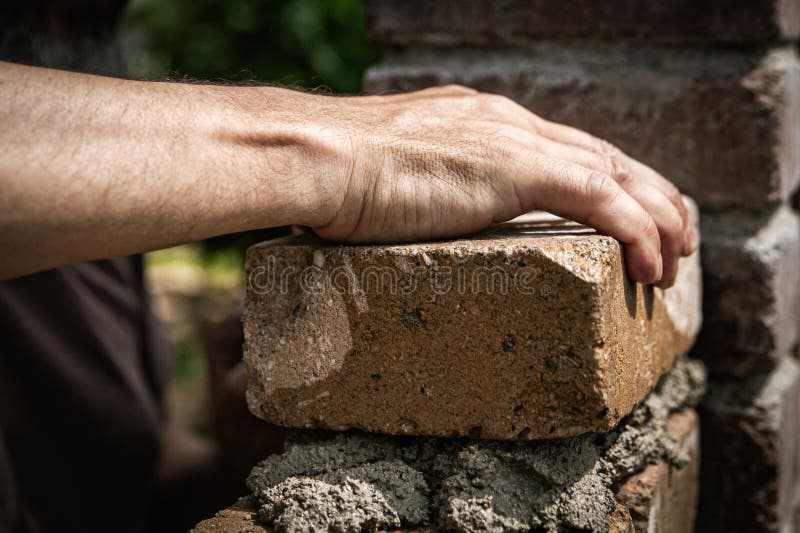 A Man is Building a Wall with Historic Looking Bricks Stock Image ...