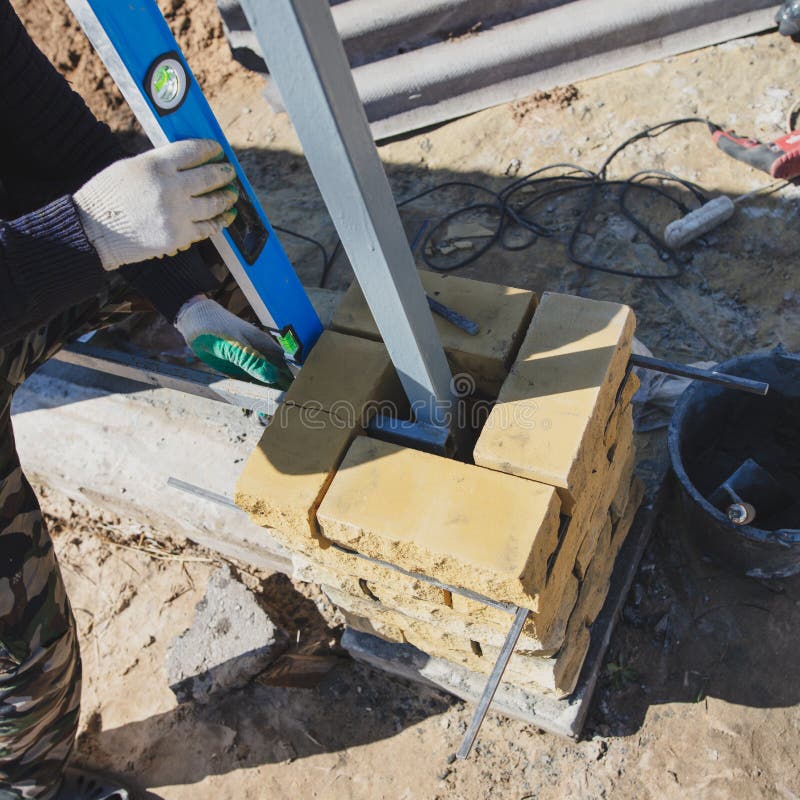 Man Builds a Brick Wall at a Construction Site Stock Image - Image of ...