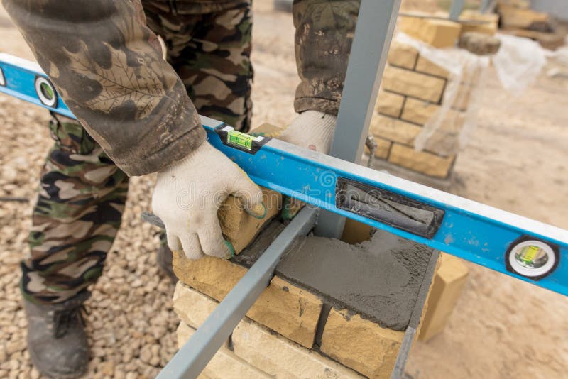 Man Builds a Brick Wall at a Construction Site Stock Image - Image of ...