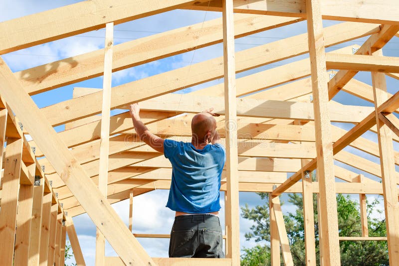 Man Builds a Wooden House, a Welder Stock Photo - Image of sparks ...