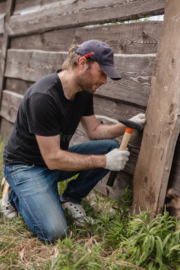 Man Builds Sections of Fence Around His Yard Out of Plank Stock Image ...