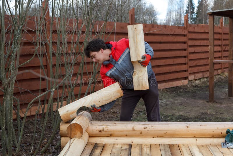 Man Builds Structure Made of Logs Stock Image - Image of fence, board ...