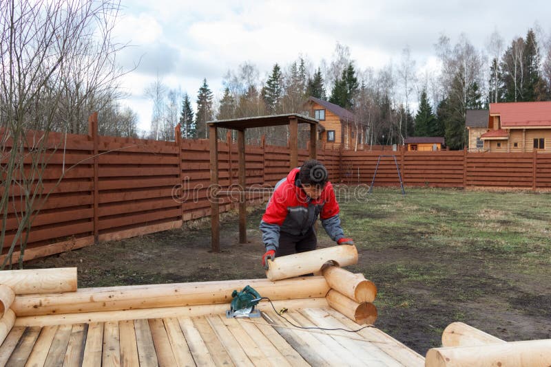 Man Builds Structure Made of Logs Stock Photo - Image of bare, rural ...