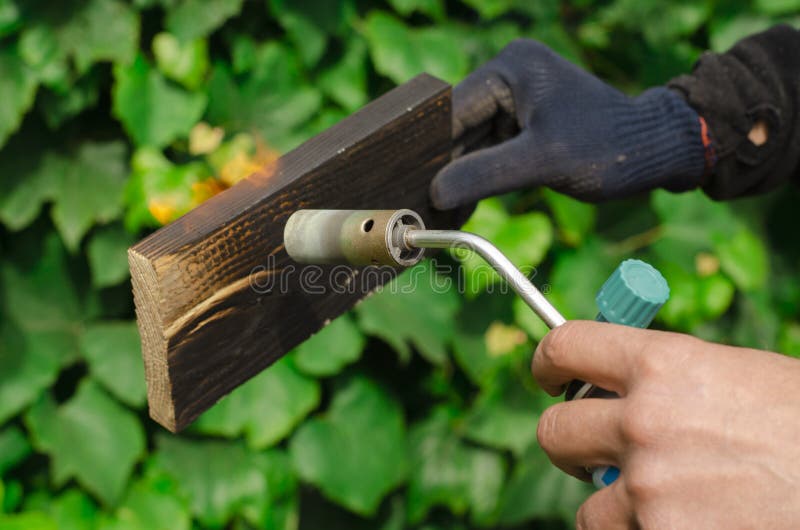 A Man Burns Boards with Fire from a Gas Burner. Stock Image - Image of ...