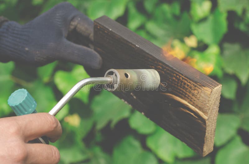 A Man Burns Boards with Fire from a Gas Burner. Stock Image - Image of ...