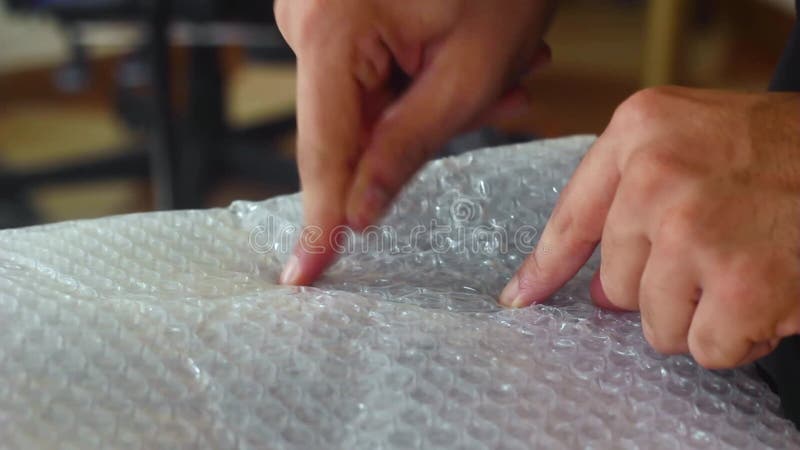 Man Bursts Bubbles on a Packaging Bubble Wrap Stock Video - Video of fragile, wrap: 257754815