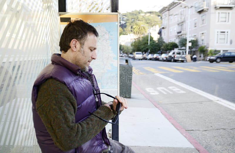 Man at a bus stop stock photo. Image of padded, white - 22715200
