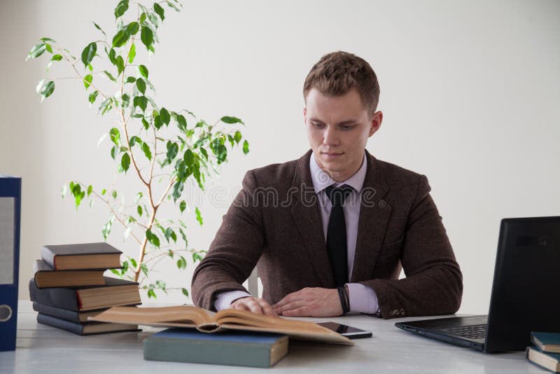 A Man in a Business Suit Works at a Computer in the Office Stock Photo ...