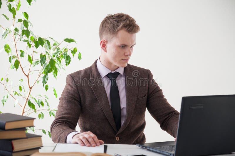 A Man in a Business Suit Works at a Computer in the Office Stock Image ...