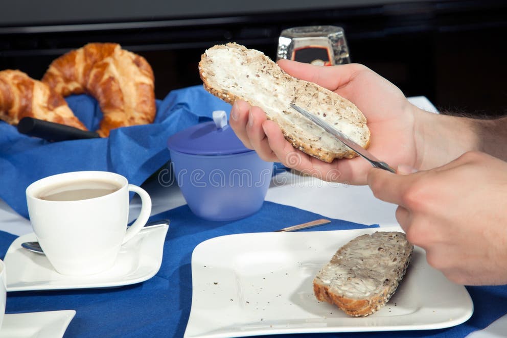 Man Buttering His Breakfast Roll Stock Photo - Image of diet, holding ...