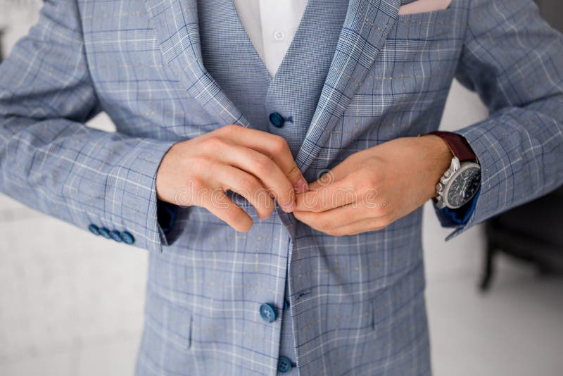 A Man Buttons Up the Buttons of a Blue Suit Jacket Stock Photo - Image ...