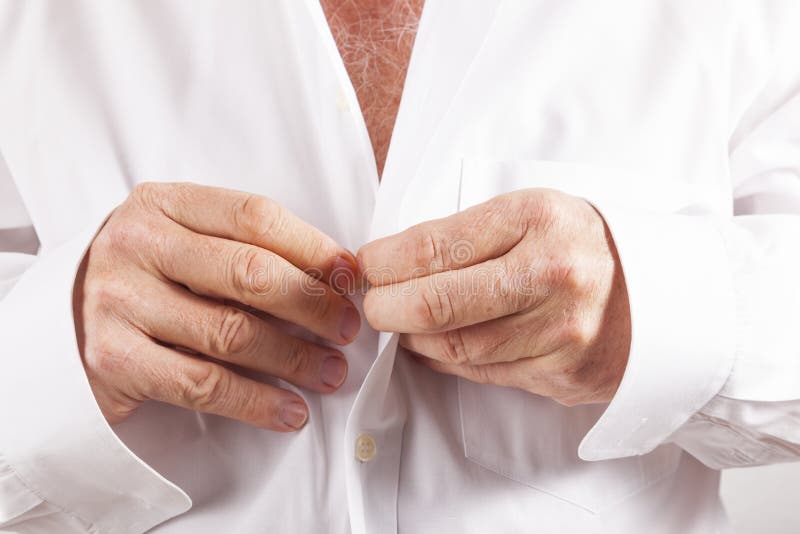 Man buttons up his shirt stock photo. Image of hands - 37153534