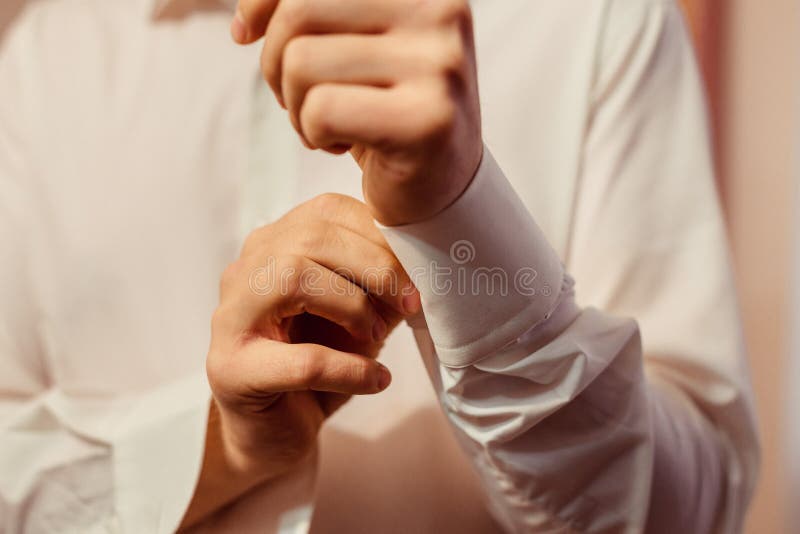 Man Buttons Up His Sleeves on Beige Shirt Stock Photo - Image of europe ...