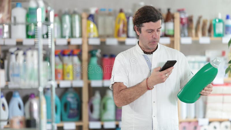Man Buyer Scans Qr Code on Liquid Laundry Powder Label Stock Footage ...