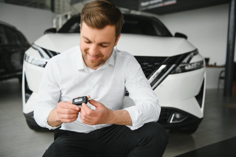 Man Buying a Car at a Showroom Stock Photo - Image of smiling, happy ...