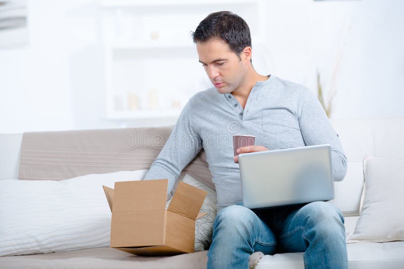 Man buying online stock image. Image of enjoyment, cheerful - 259959187