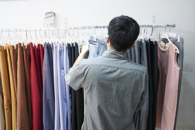 Man buying pants stock image. Image of boutique, trousers - 135268151