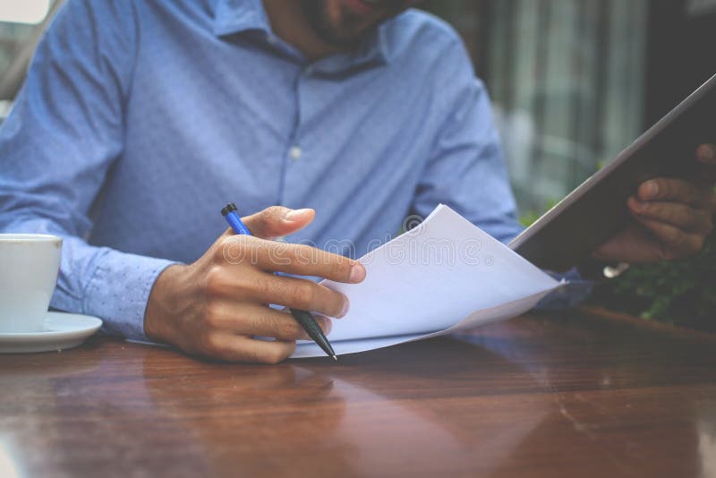 Man in Cafe Using Digital Tablet and Writing on Paper. C Stock Image ...