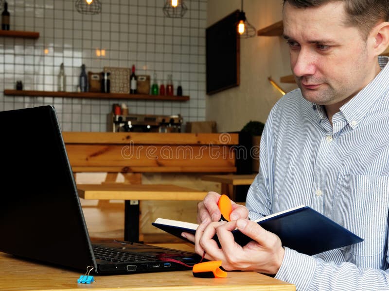Man in the Cafe Working with Laptop and Papers Stock Image - Image of ...