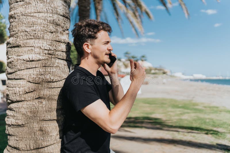Man Calmly Talks on the Phone while Enjoying a Beach Side View. Stock ...