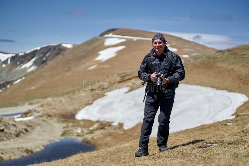 Man with Camera in the Mountains Stock Image - Image of energetic ...