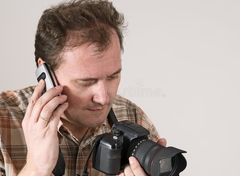 Man with camera and phone stock photo. Image of photographer - 5705864