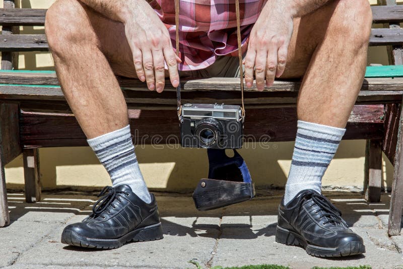 Man with Camera Sitting on a Bench Stock Image - Image of sitting, legs ...