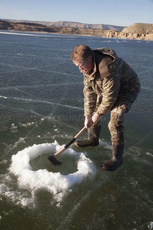 Man in Camo Chopping Hole in Ice with Axe Swing Stock Photo - Image of ...