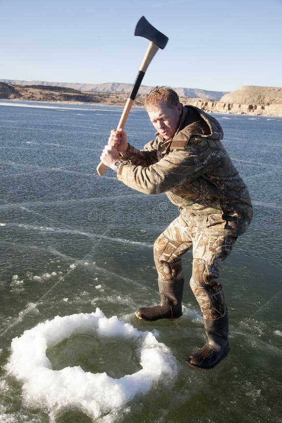 Man in Camo Chopping Hole in Ice with Axe Swing Stock Photo - Image of ...
