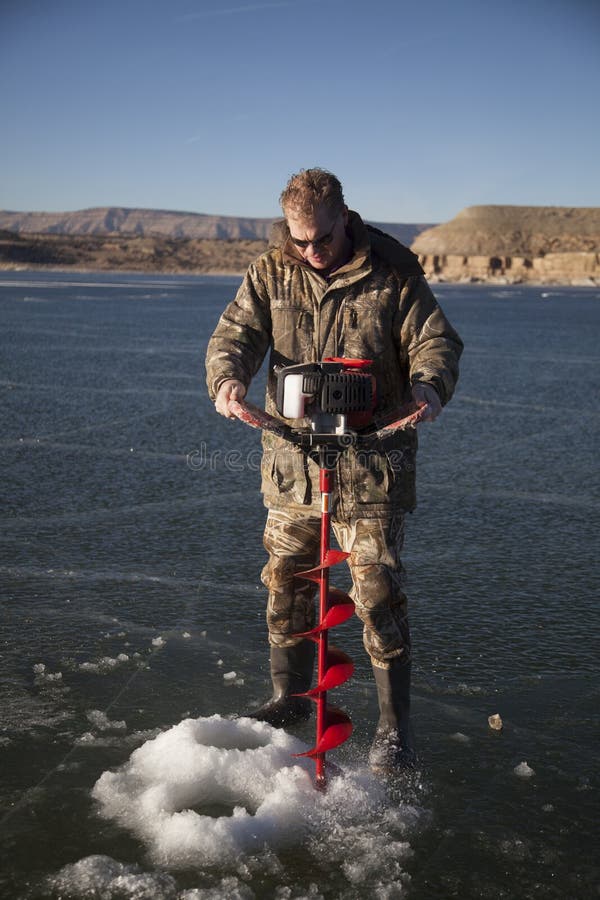 Man in Camo Drilling Hold in Ice with Auger Stock Photo - Image of blue ...
