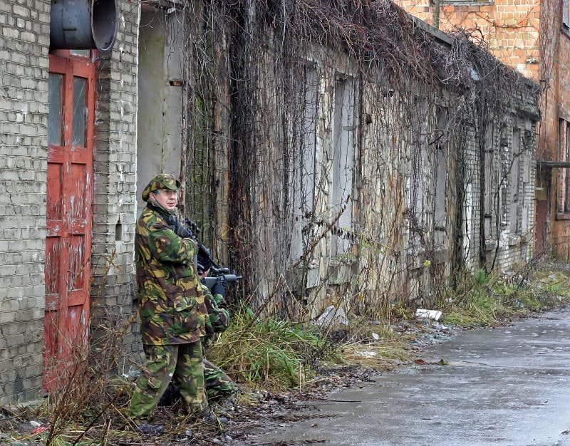 Man in camouflage with gun stock photo. Image of trees - 3739082