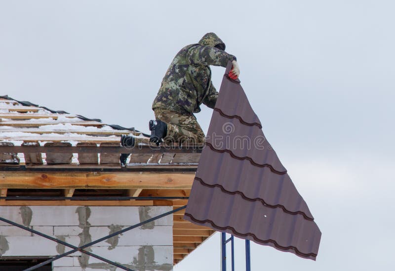 A Man in Camouflage is Working on a Roof Stock Image - Image of build ...