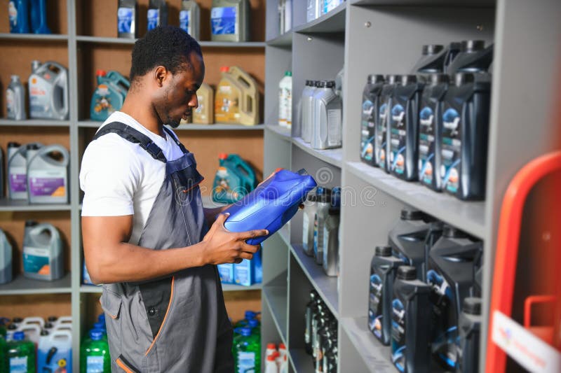 Man with Canister of Motor Oil in Auto Store Stock Image - Image of ...