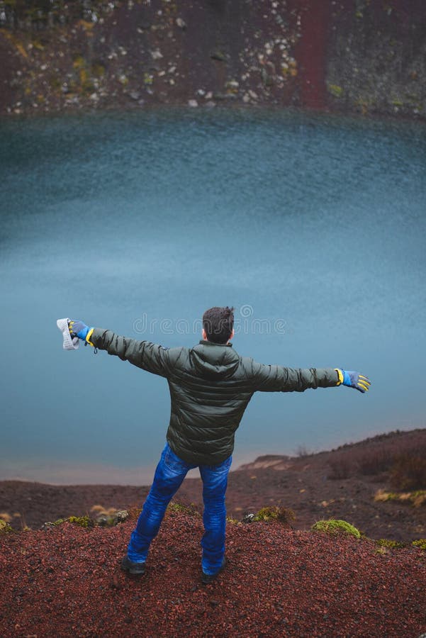 Man in Cap on Red Volcano Ground Stock Photo - Image of tourist, ground ...