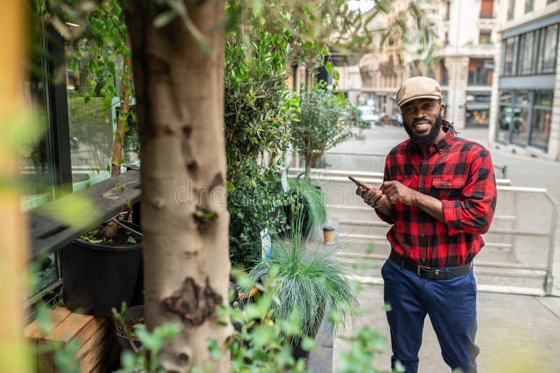 Man in a Cap in the Street Looking at the Plants Stock Photo - Image of ...