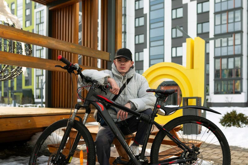 A Man in a Cap and a Warm Jacket Sat Down To Rest with a Bicycle on a ...