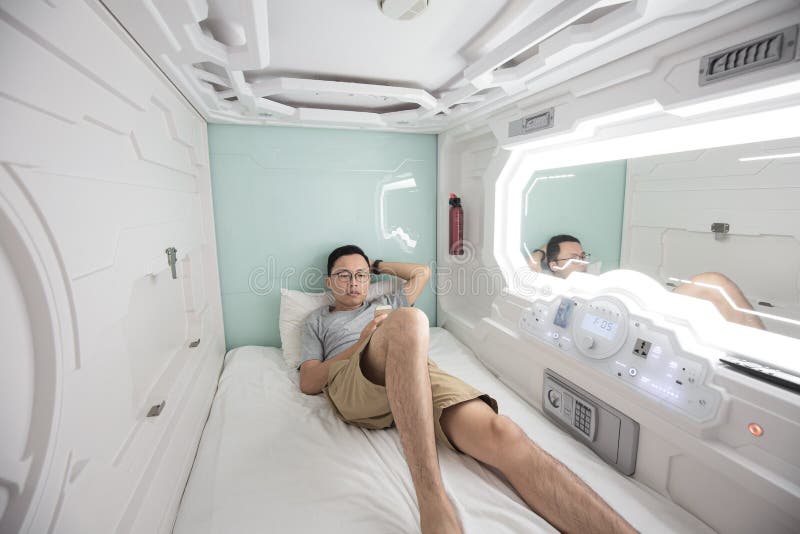 Man in capsule hotel stock image. Image of korean, mirror - 168126481