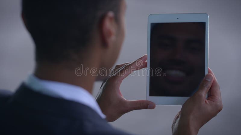 A Man Capturing a Selfie with a Tablet that Offers a Clear Reflection ...