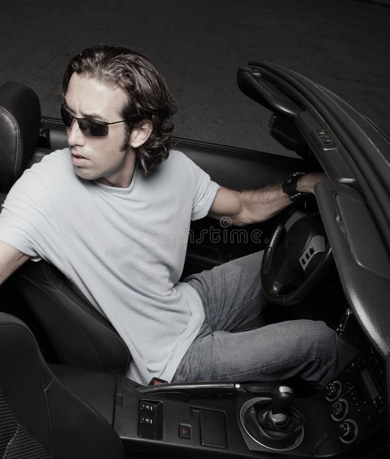 Man in a car backing up stock image. Image of male, handsome - 10582759