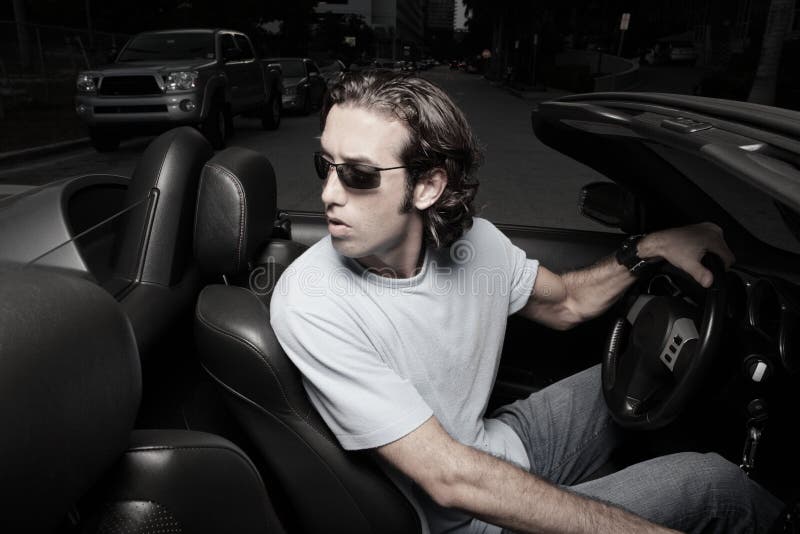 Man in a car backing up stock image. Image of convertible - 10582757