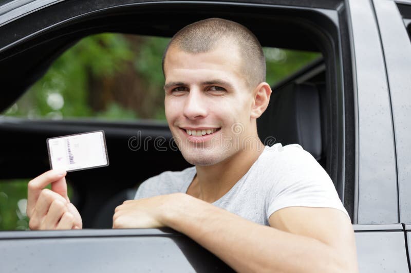 Man in Car Showing Driving Licence Stock Photo - Image of holding ...