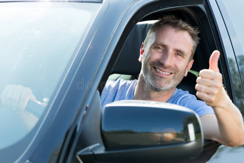 Man in car with thumbs up stock image. Image of automobile - 263614789