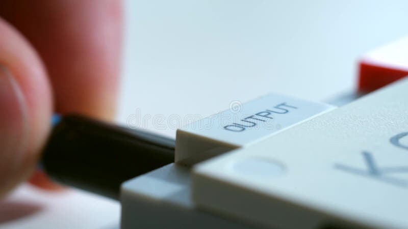 Man Carefully Inserts Wire into Output Hole of Digital Device Stock ...