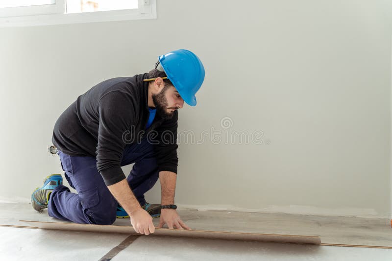 Man Worker Assembling Laminate Flooring. Stock Image - Image of ...